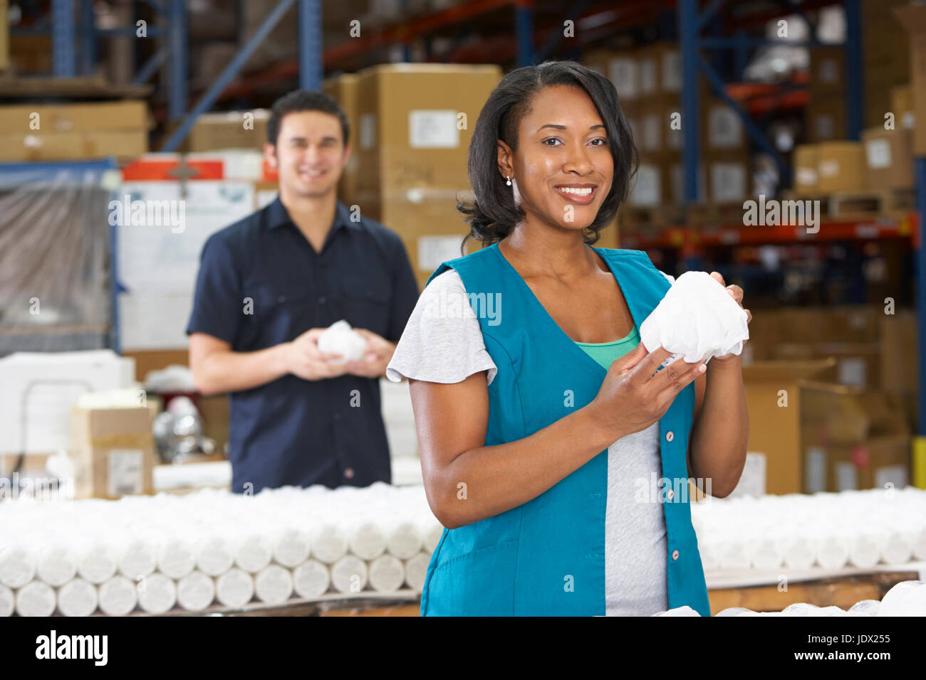 Factory Worker Checking Goods On Production Line Stock Photo - Alamy