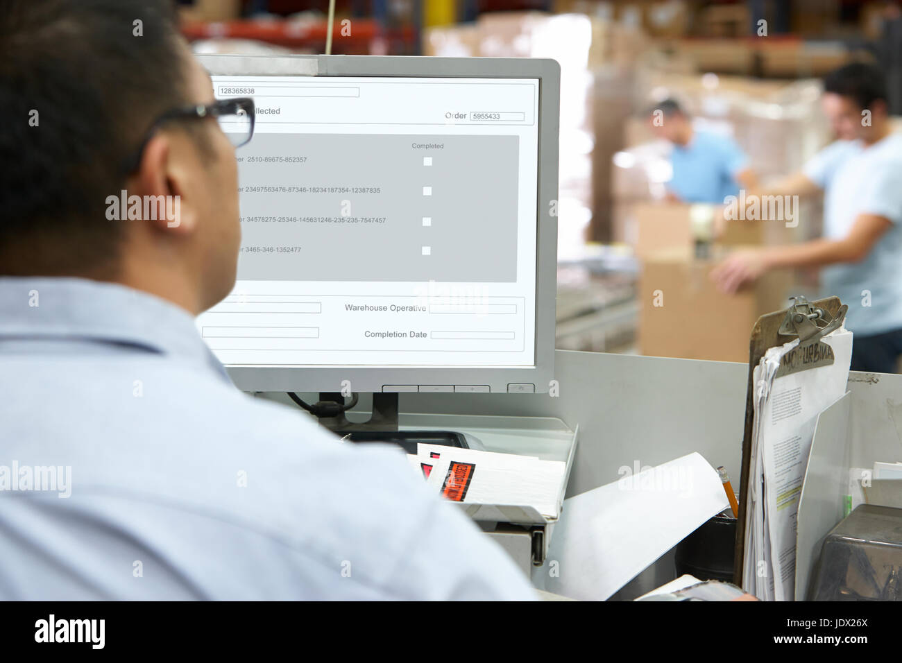 Person At Computer Terminal In Distribution Warehouse Stock Photo - Alamy