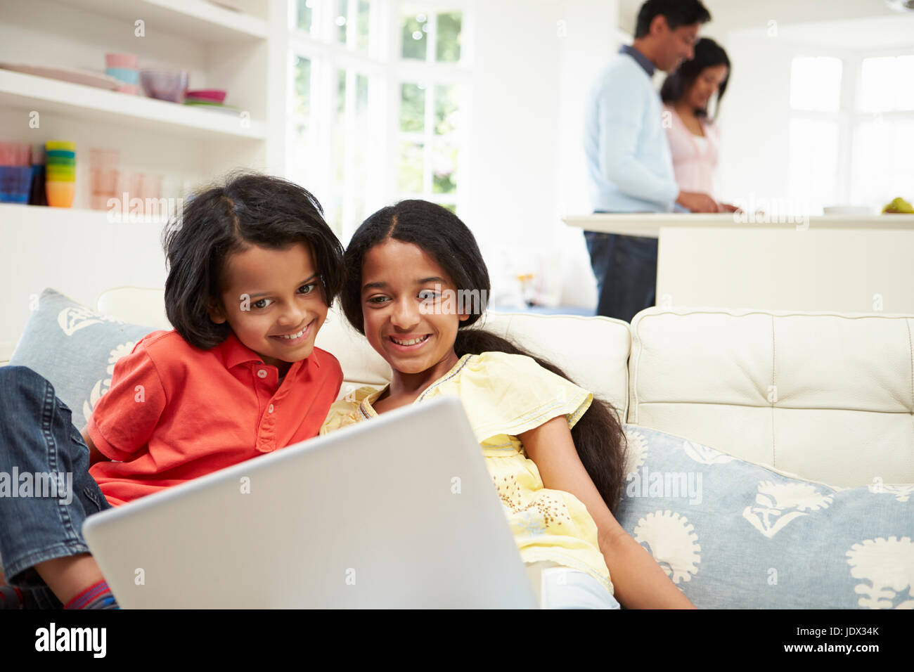 Indian Family With Laptop At Home Stock Photo - Alamy