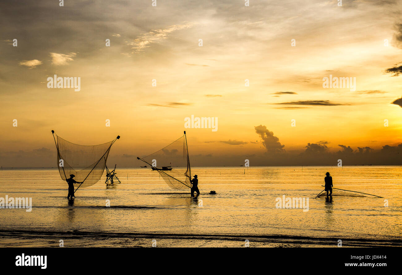 Sea clam digging fishermen golden sunrise Tan Thanh beach Go Cong Tien ...