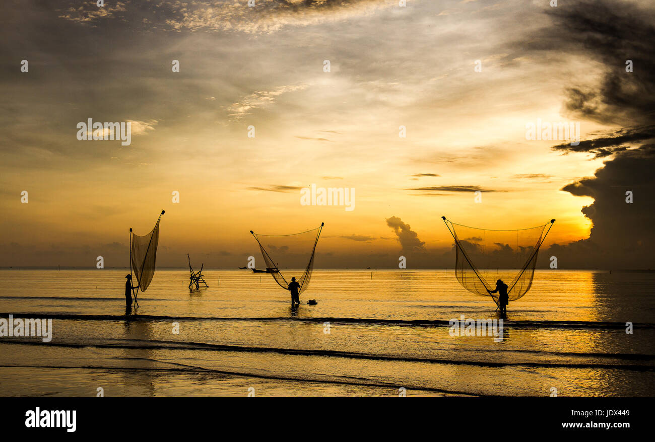 Sea clam digging fishermen golden sunrise Tan Thanh beach Go Cong Tien ...