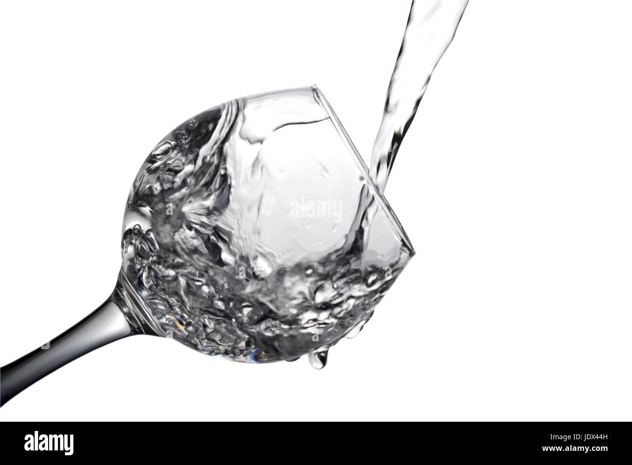 Colorless liquid, water,vodka is poured into a glass, liquid in a ...