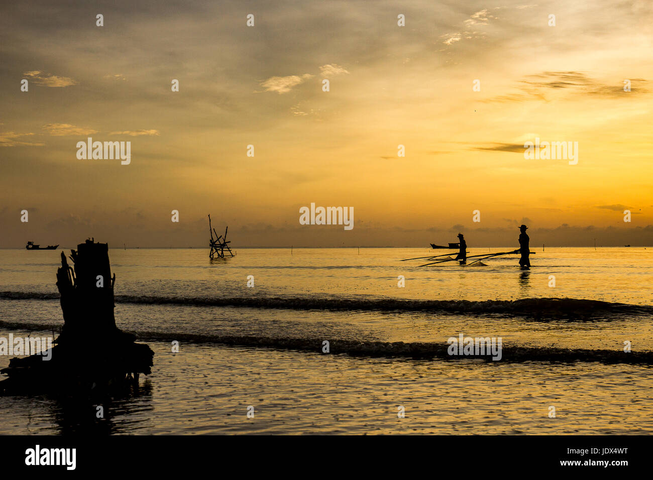 Sea clam digging fishermen golden sunrise Tan Thanh beach Go Cong Tien ...