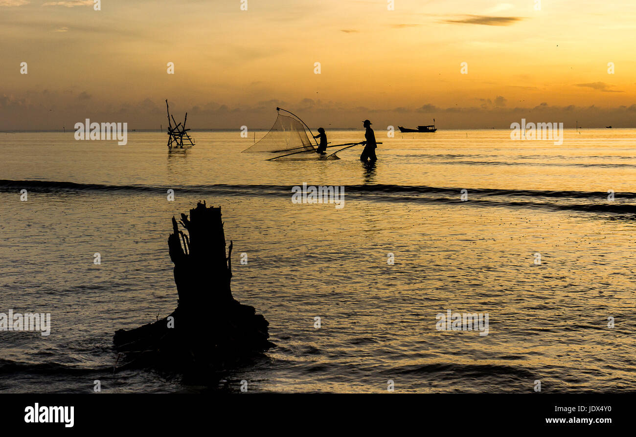 Sea clam digging fishermen golden sunrise Tan Thanh beach Go Cong Tien ...