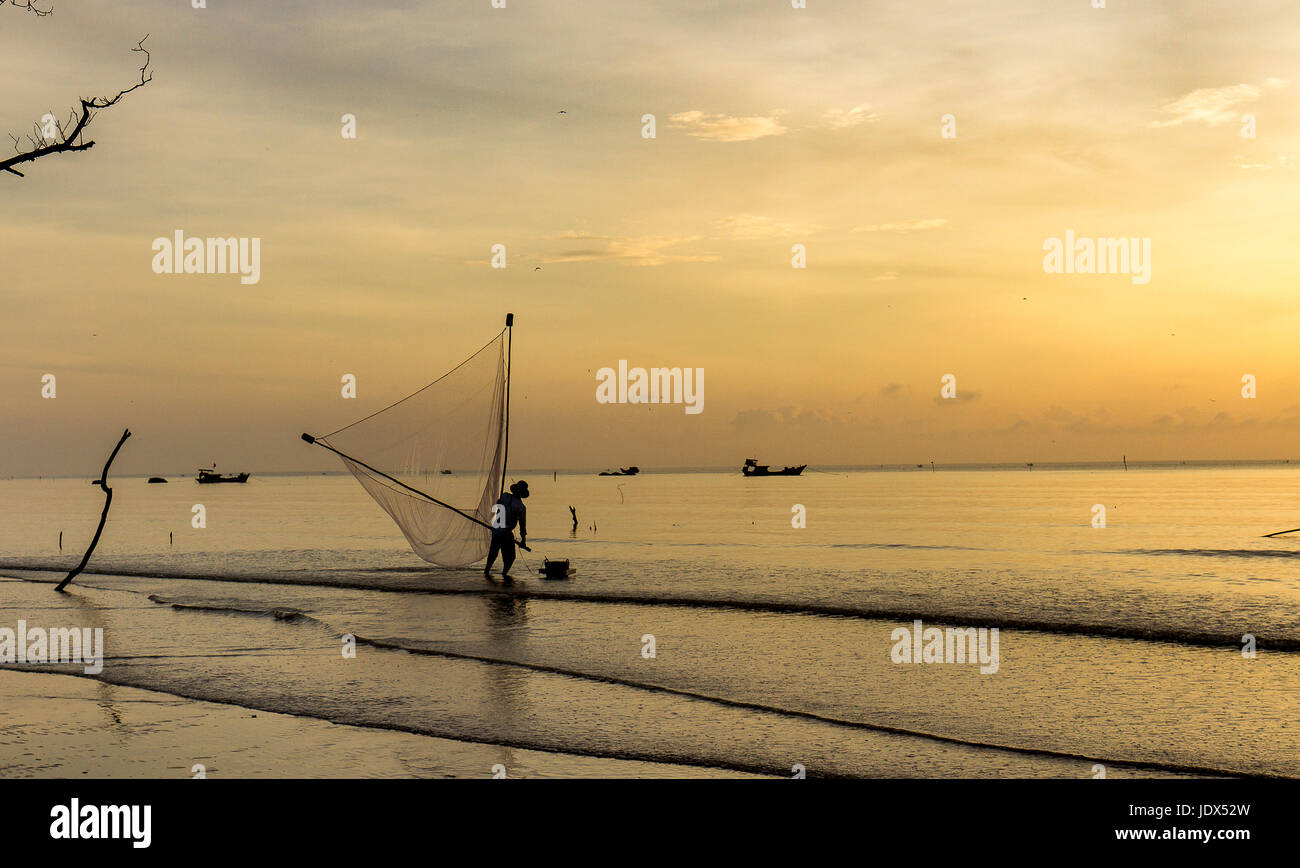 Sea clam digging fishermen golden sunrise Tan Thanh beach Go Cong Tien ...
