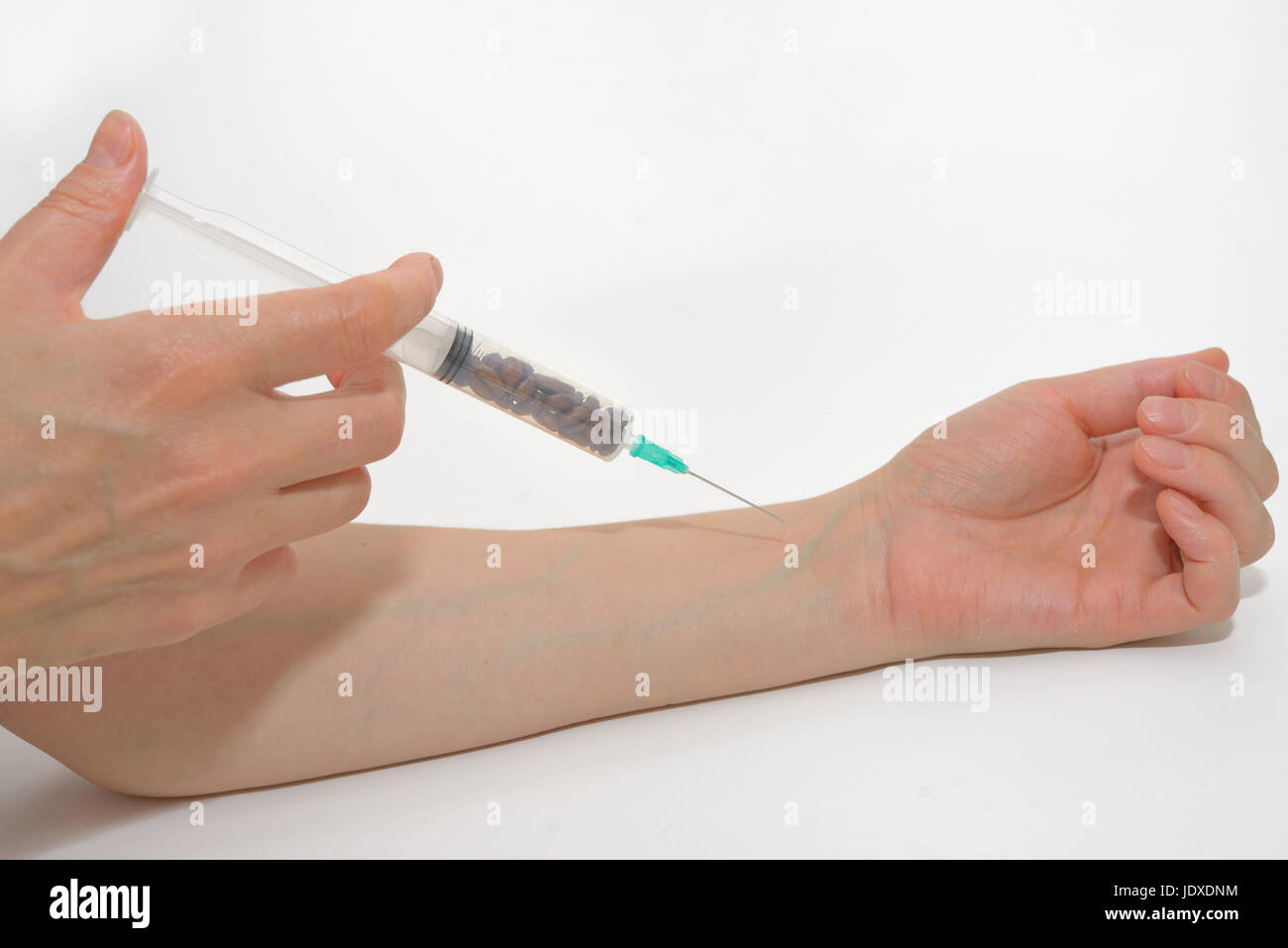 Coffee beans in syringe acting injection Stock Photo - Alamy