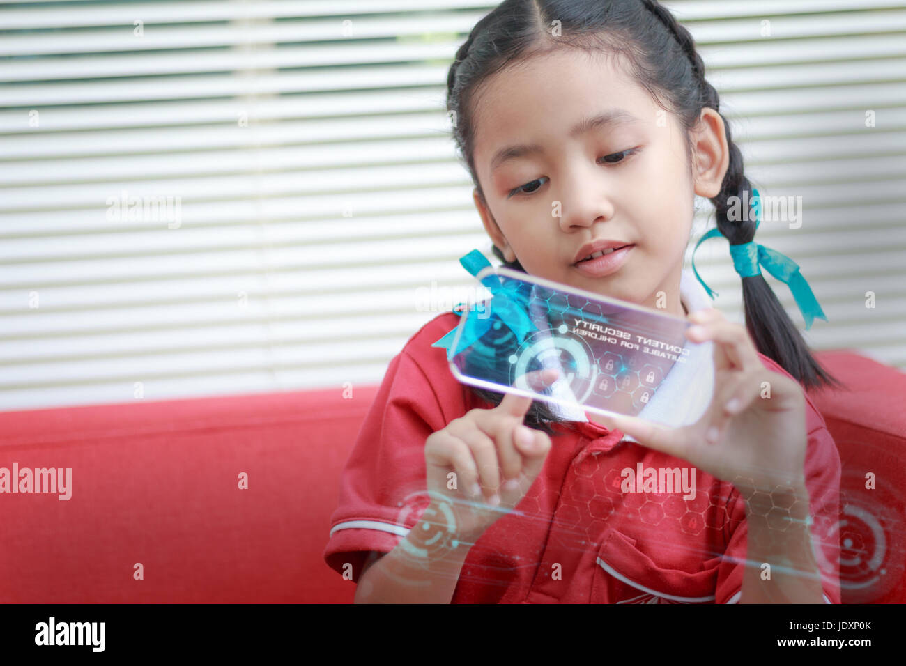 Asian little girl using mobile smart phone with HUD head up display ...
