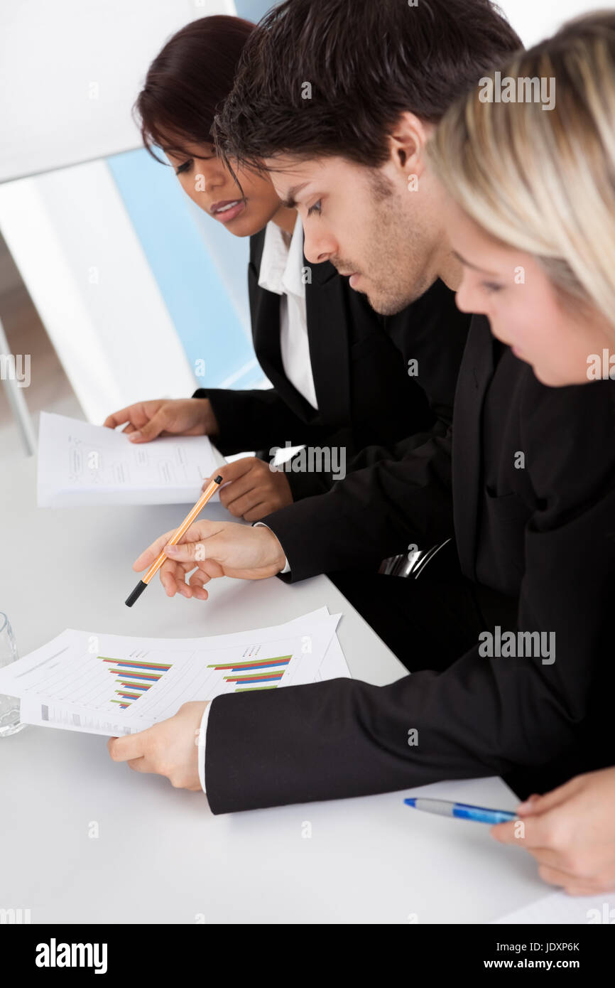 Group of business people looking at charts in the meeting Stock Photo ...