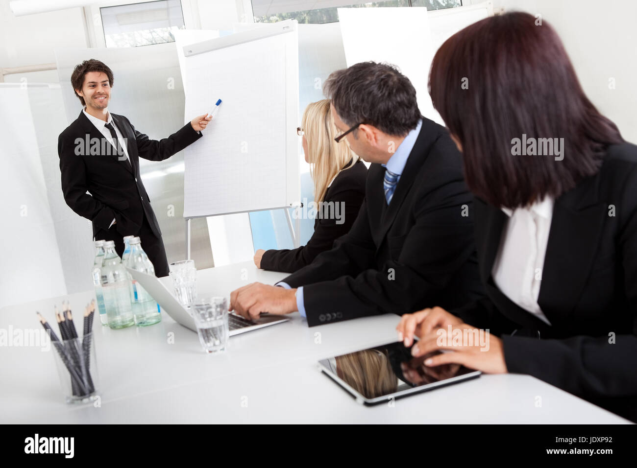 Group of business people at presentation in the office Stock Photo - Alamy