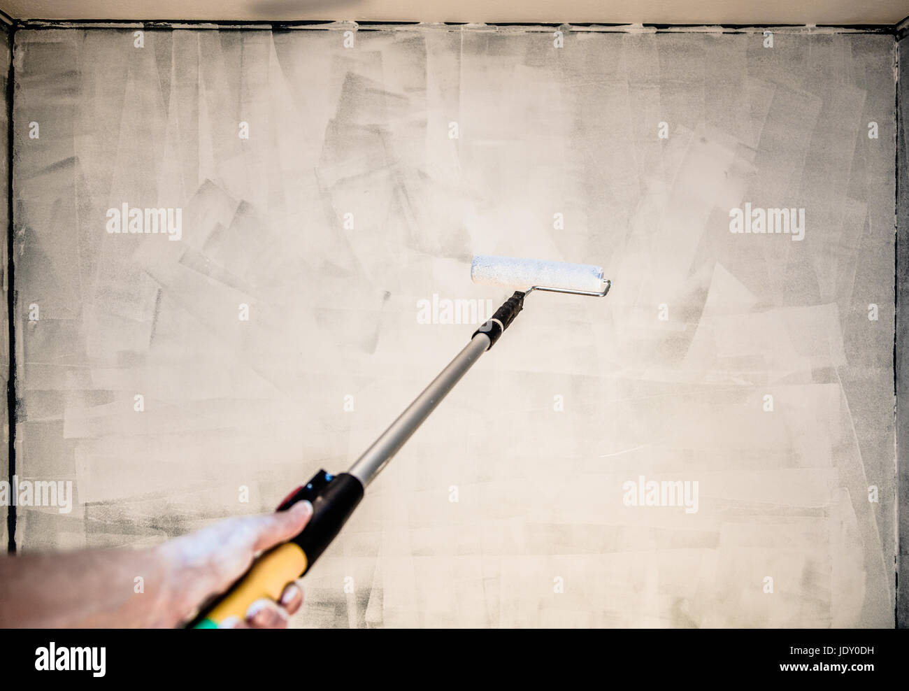 POV of Someone Painting the Wall with Roller Pin Stock Photo - Alamy