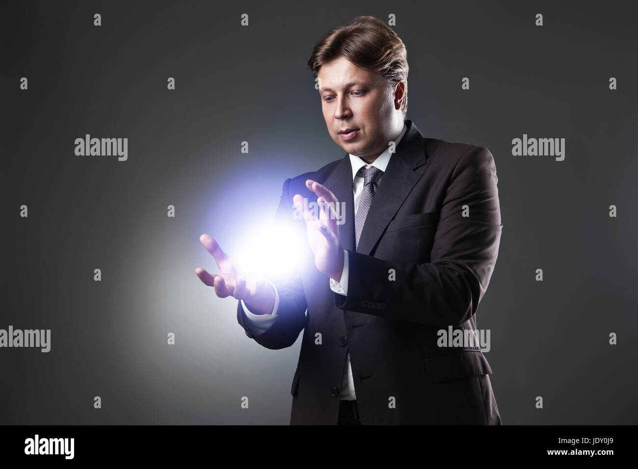 Hand of Business Man Hold light on dark background Stock Photo - Alamy