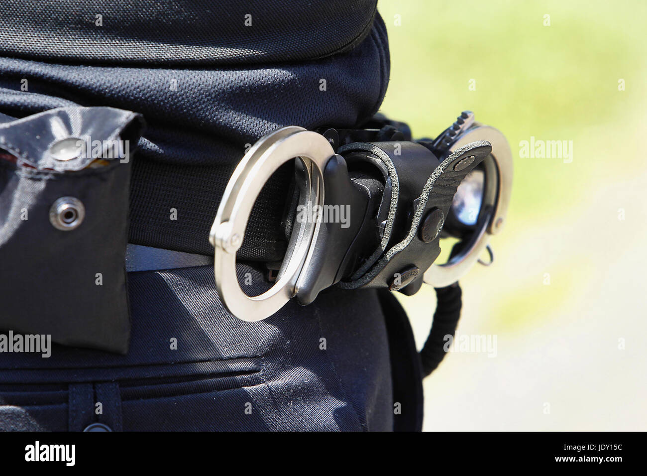 Law & Order, Police officers belt with handcuffs Stock Photo - Alamy