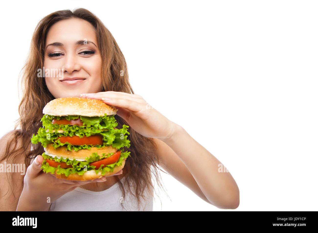 Happy Young Woman Eating big yummy Burger isolated on white background ...