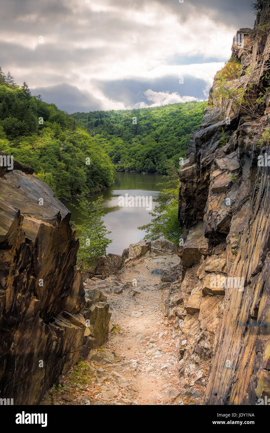 Landscape with country pathway through rocks along a river, dramatic ...