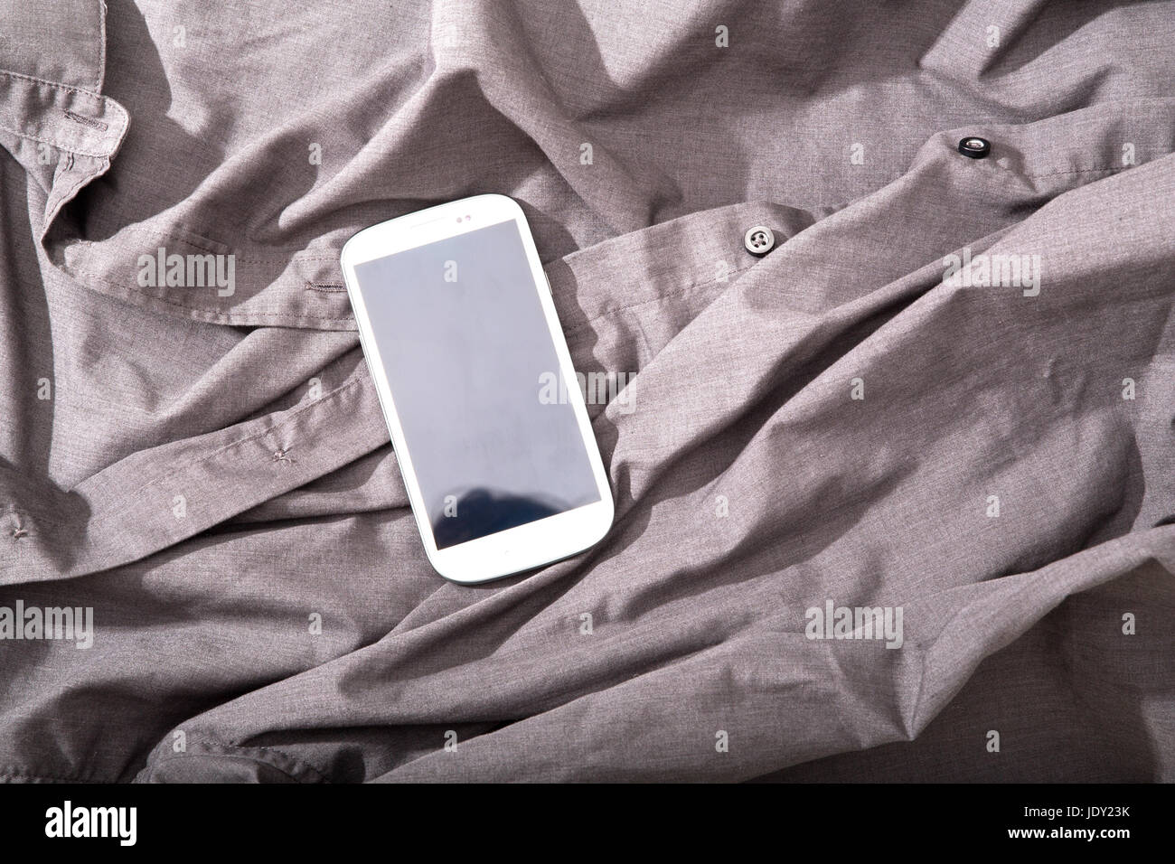 A Smartphone on some dark cloth Stock Photo - Alamy