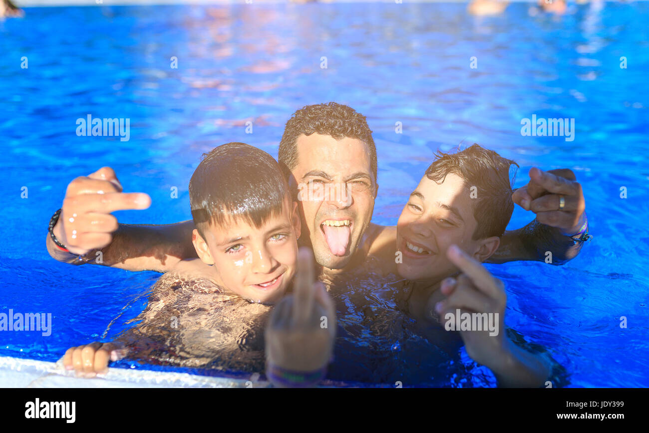 Friends playing in the swimming pool Stock Photo - Alamy
