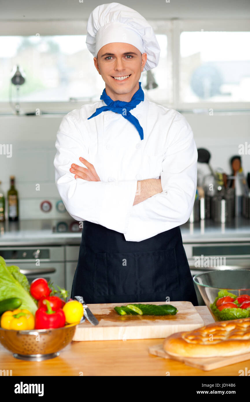 Young handsome male chef with folded arms Stock Photo - Alamy