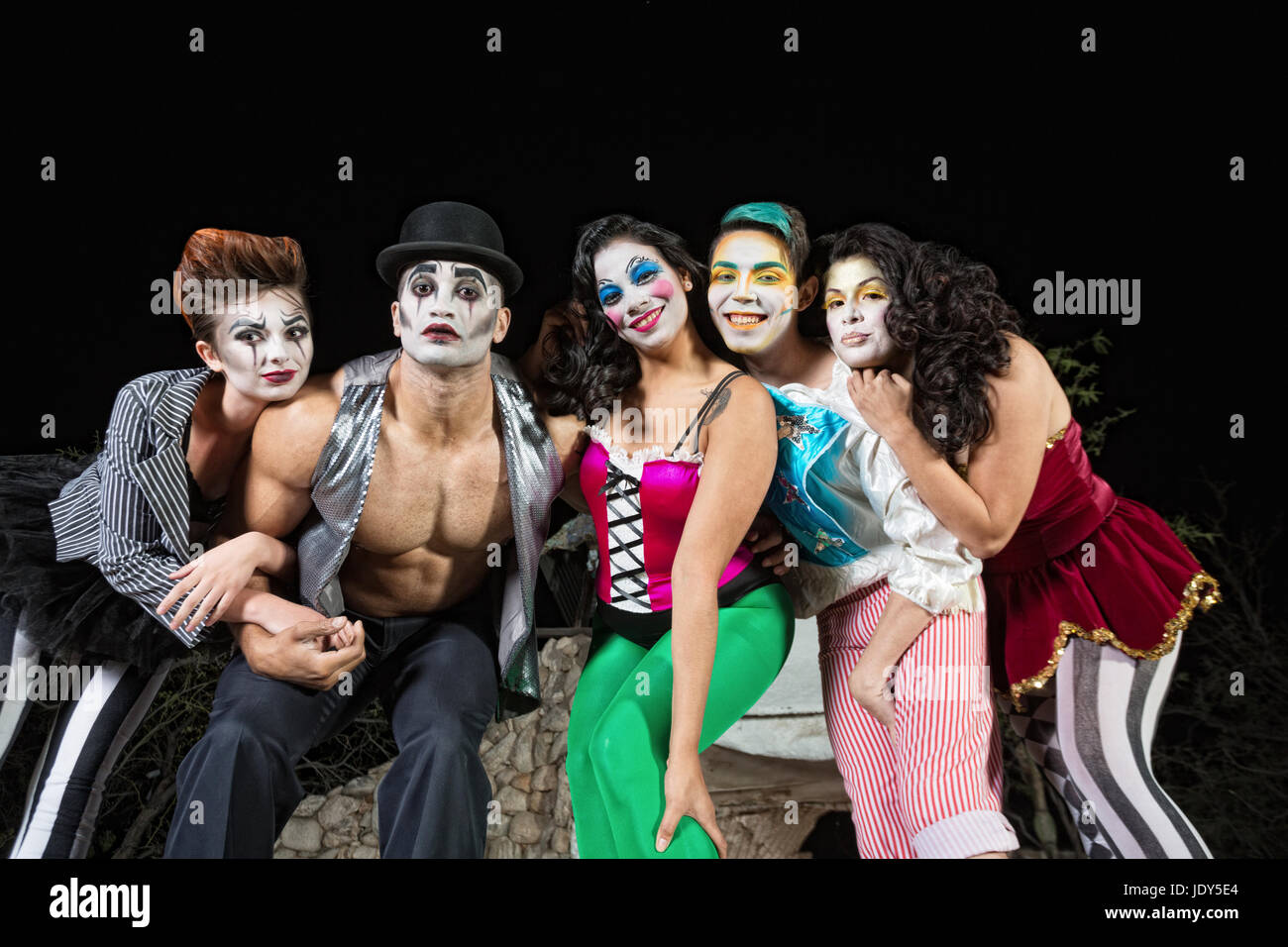 Group of character clowns posing on stage Stock Photo - Alamy