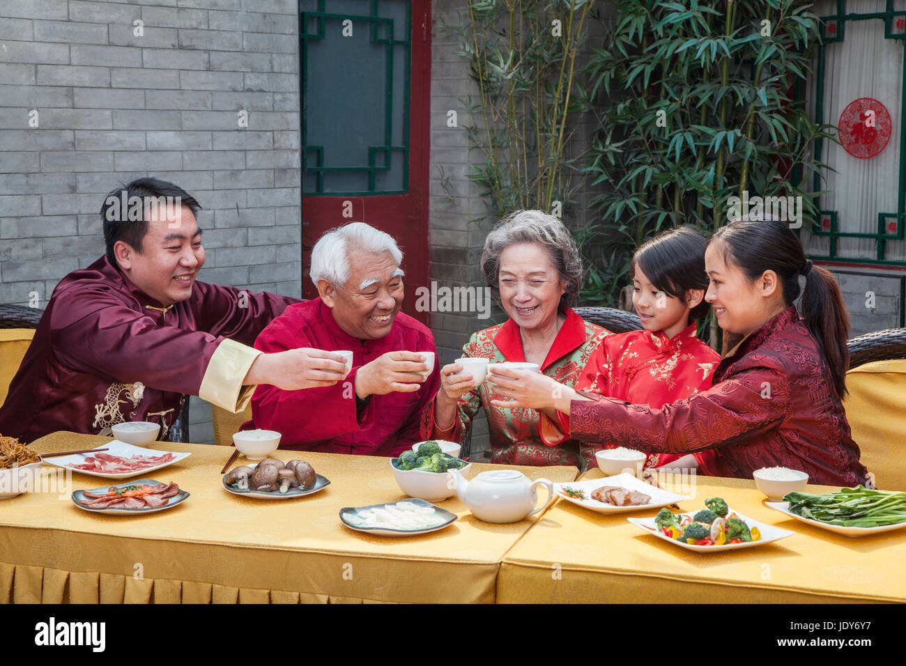 Smiling chinese family raised hi-res stock photography and images - Alamy