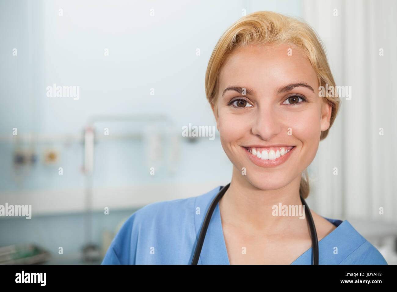Front view of a nurse smiling while looking at camera in hospital ward ...