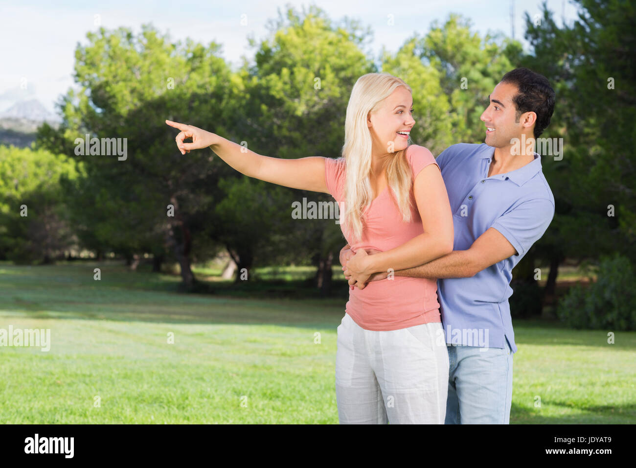 Woman pointing something out to partner in the park Stock Photo - Alamy