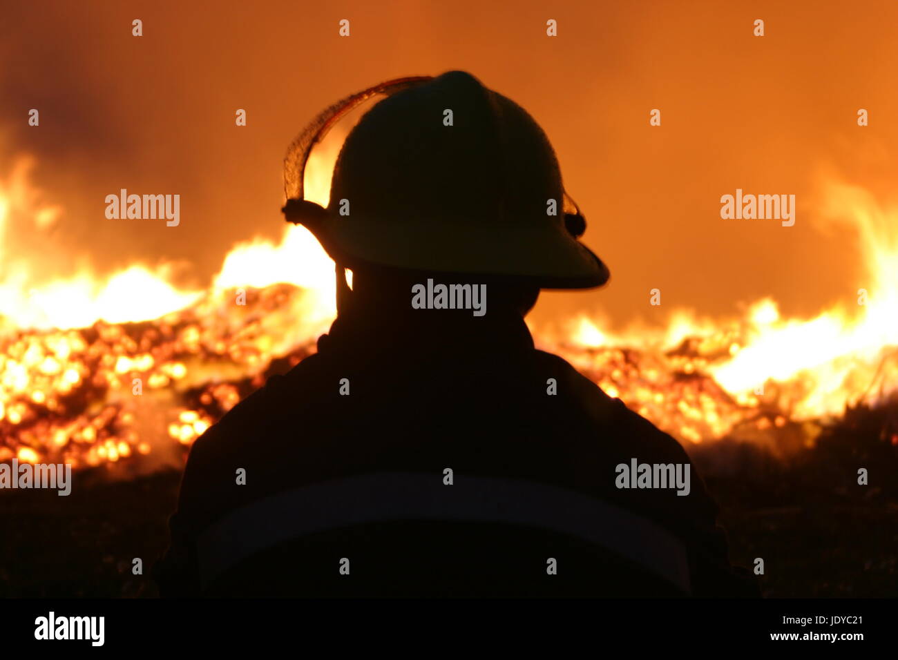 fire fighter fighting inferno Stock Photo - Alamy