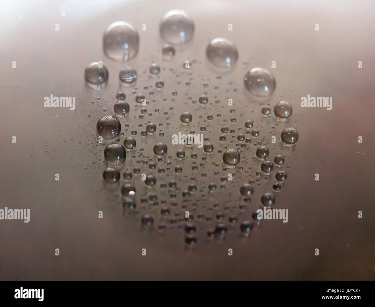 a circle of bubbles on top of a grey shiny surface detail Stock Photo ...