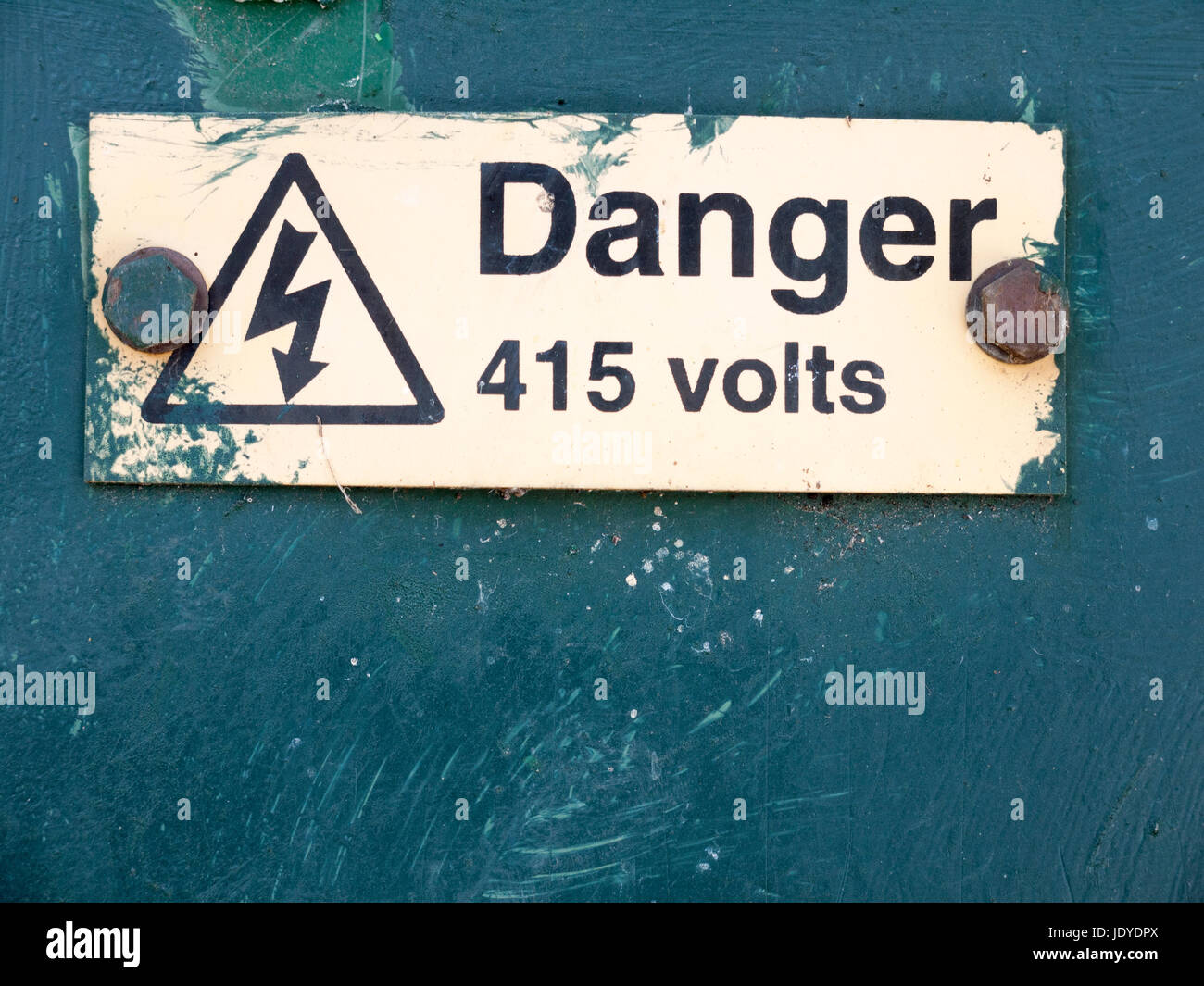 yellow rusted nailed sign on metal box yellow with danger arrow Stock ...