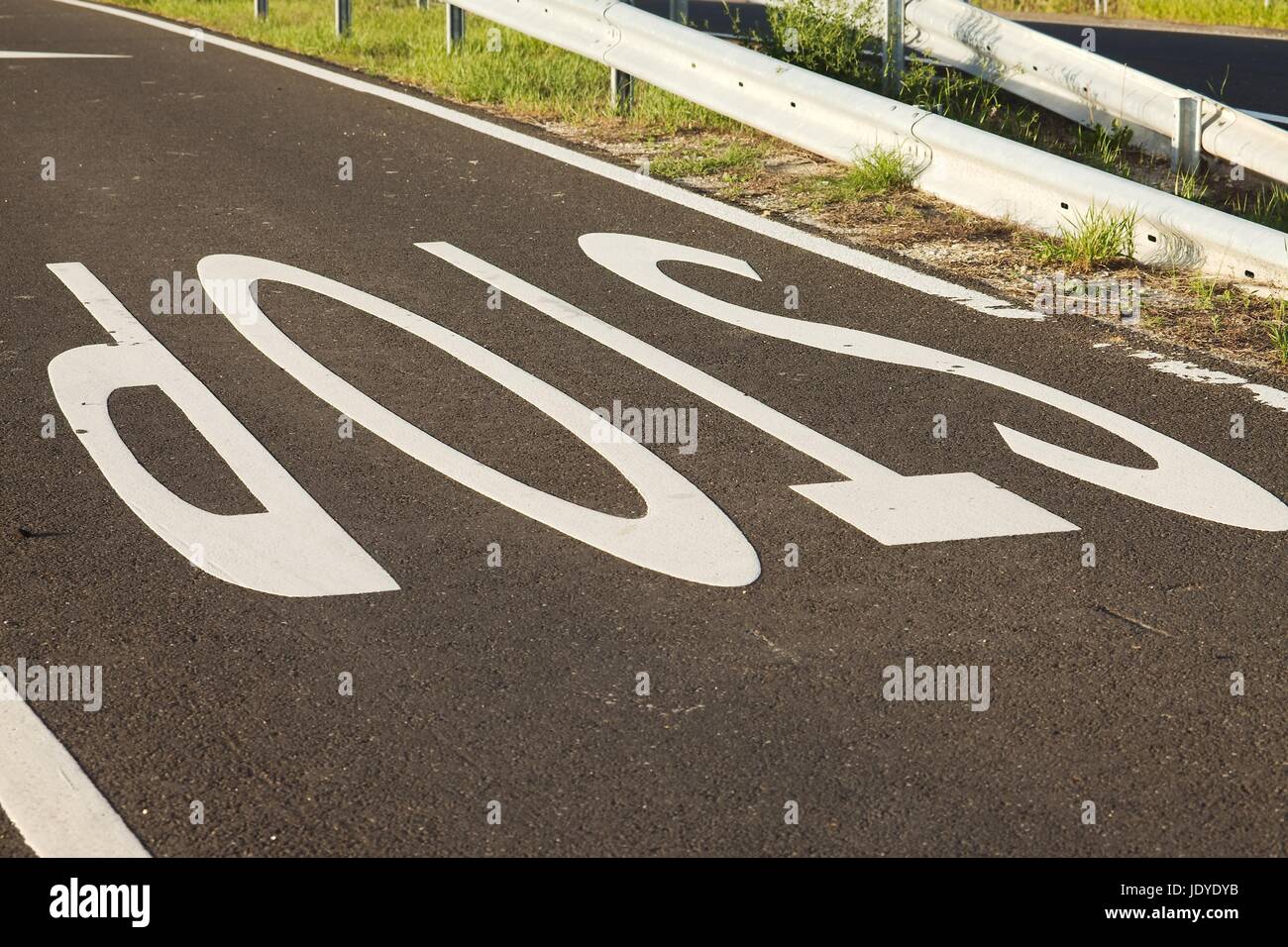 Stop sign painted on the road Stock Photo - Alamy