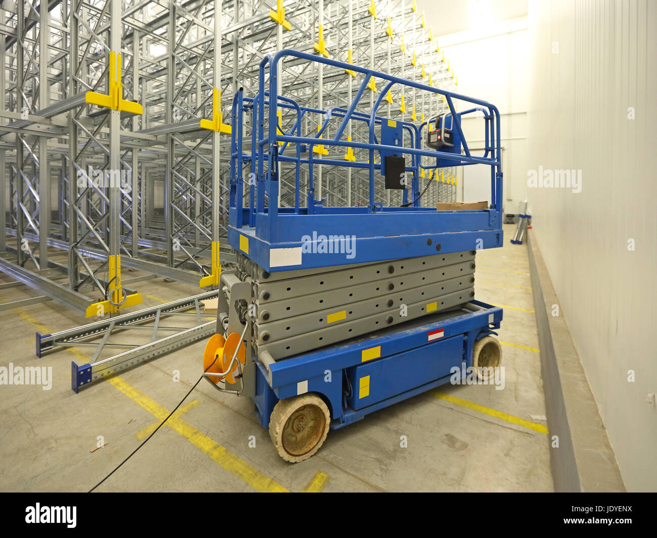 Scissor lift aerial work platform in warehouse Stock Photo - Alamy