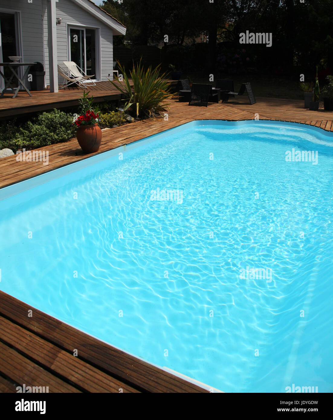 Closeup of swimming pool with wooden floor around Stock Photo - Alamy