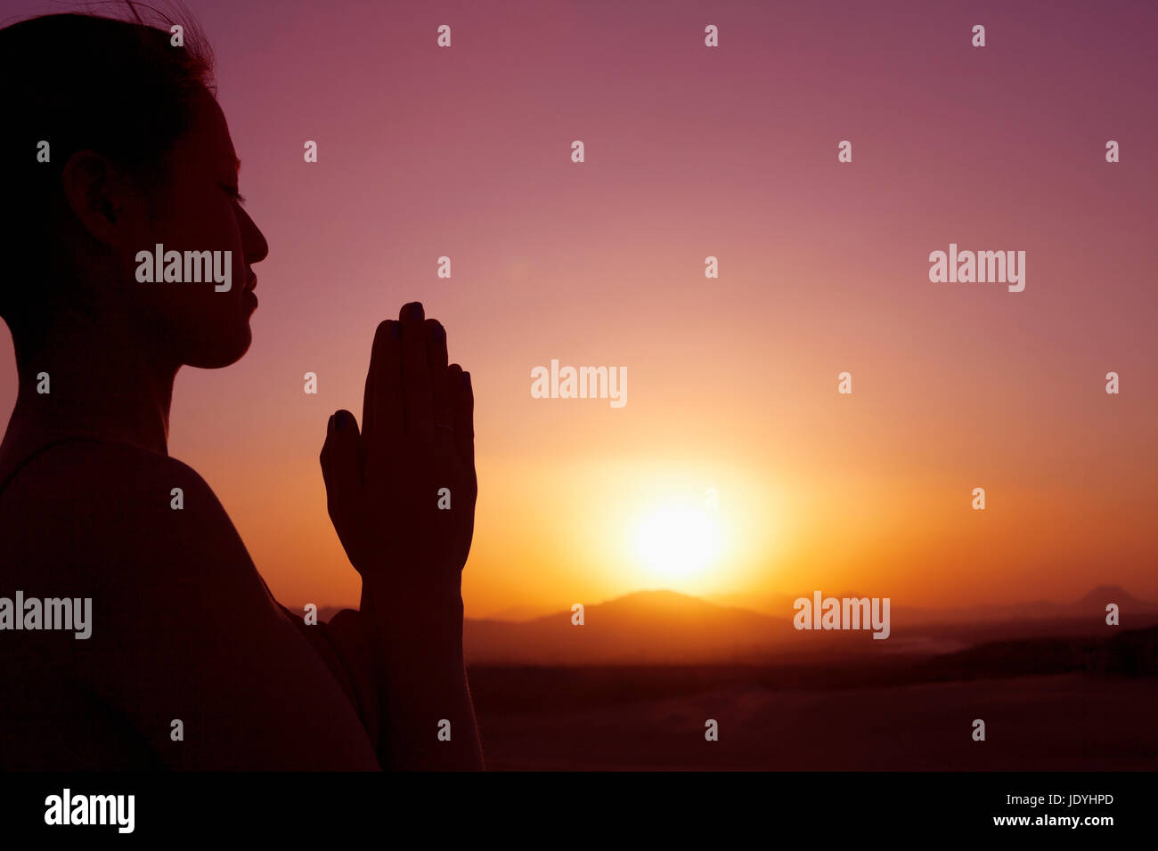 Silhouette praying hands side view hi-res stock photography and images ...