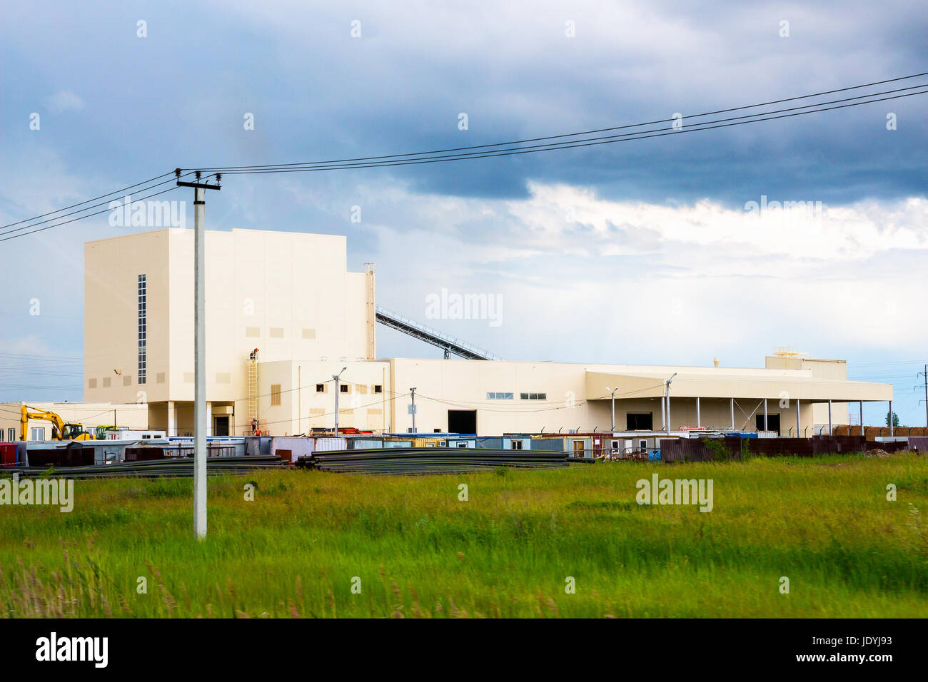 Small factory in the background Stock Photo - Alamy