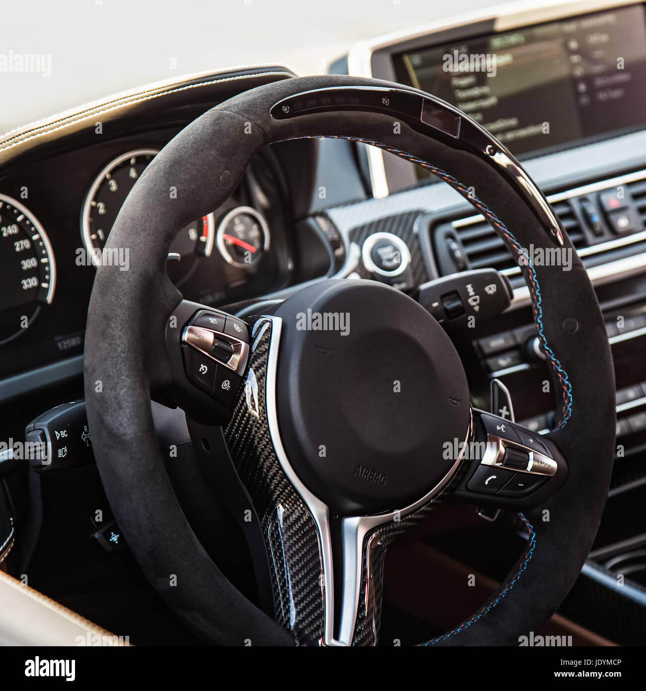 Steering wheel in interior of the sports car Stock Photo - Alamy