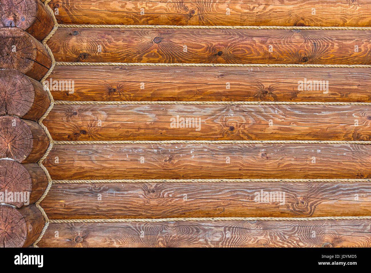 Wooden logs wall with rope of rural house background Stock Photo - Alamy
