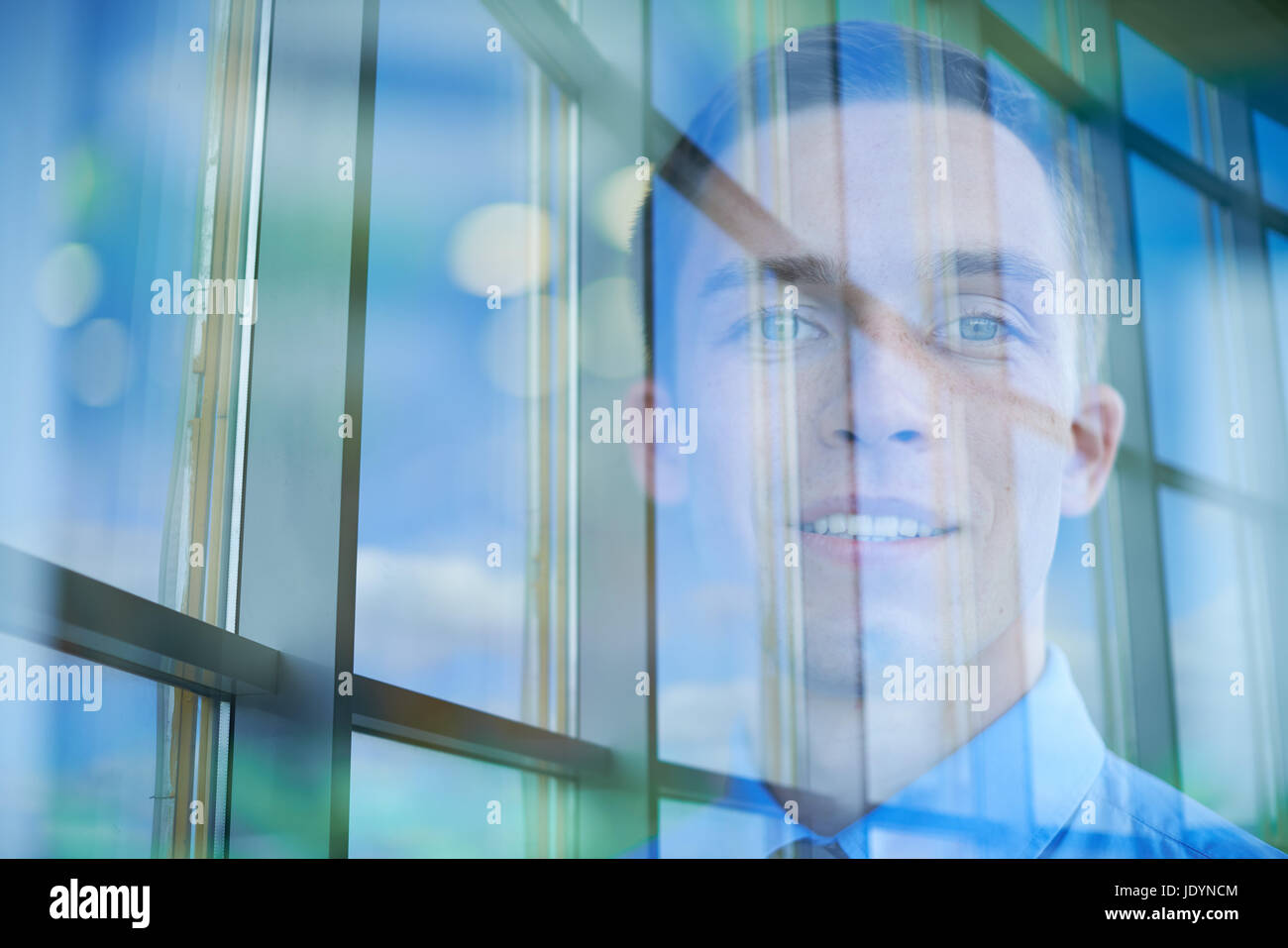 Face of young man looking at camera and window Stock Photo - Alamy