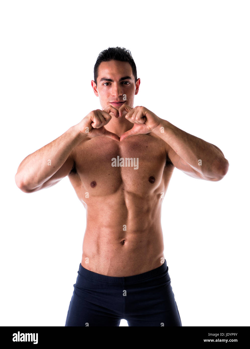 Shirtless muscular man making heart symbol with his hands on white ...