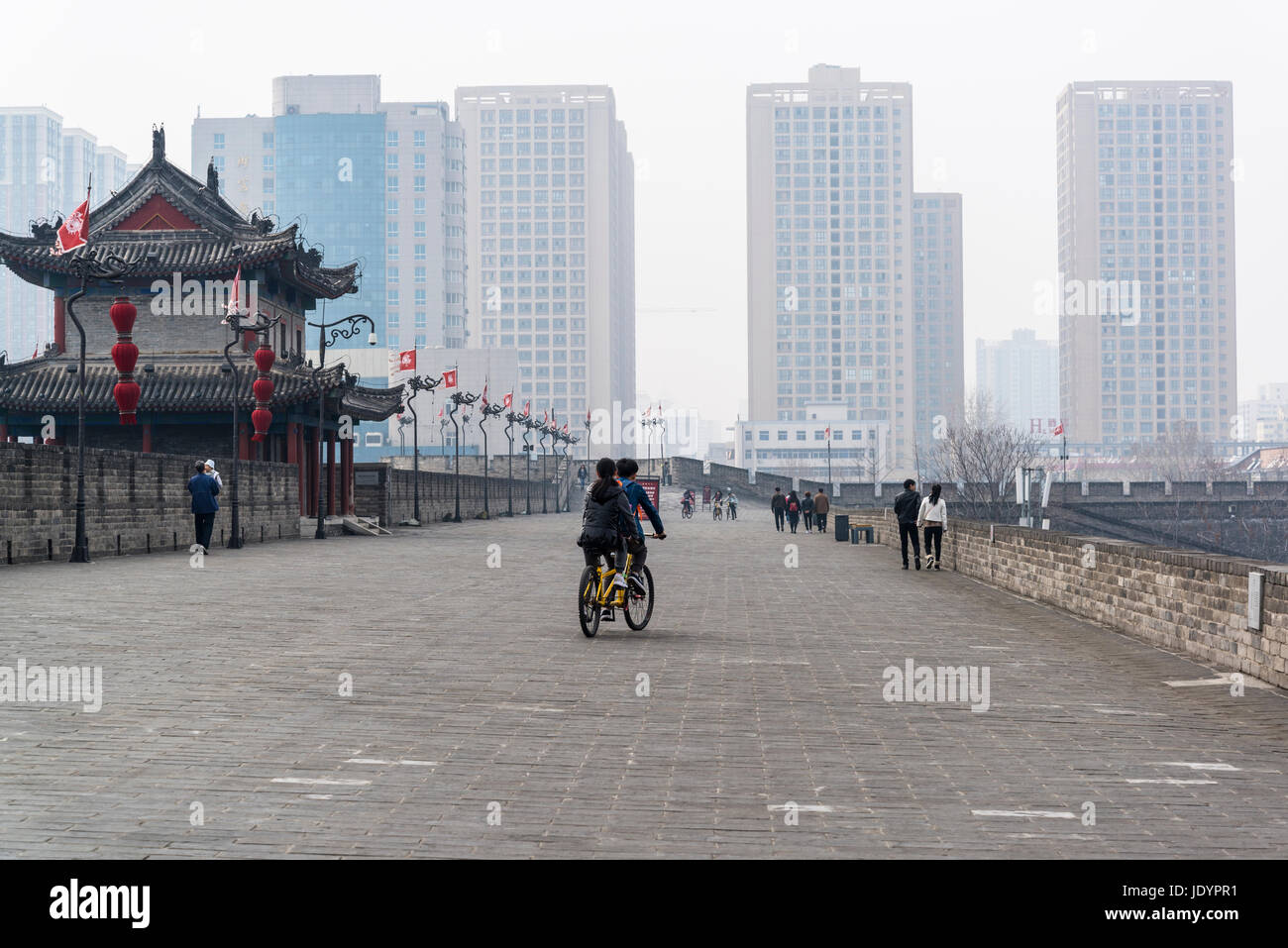 Cycling on the ancient City Wall and modern high-rise tower blocks in ...
