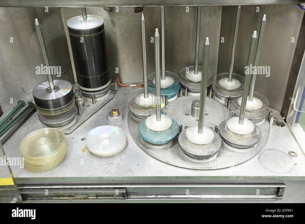 Compact disc and DVD at spindles in factory Stock Photo - Alamy