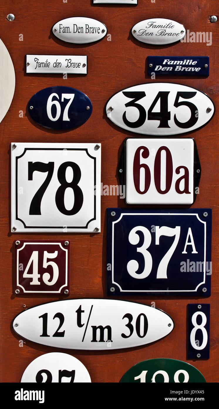 Collection of metallic plates with numbers and surnames Stock Photo - Alamy