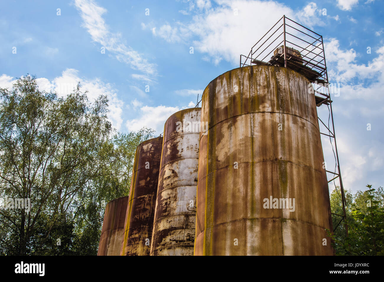 Big old deserted rusty tanks Stock Photo - Alamy