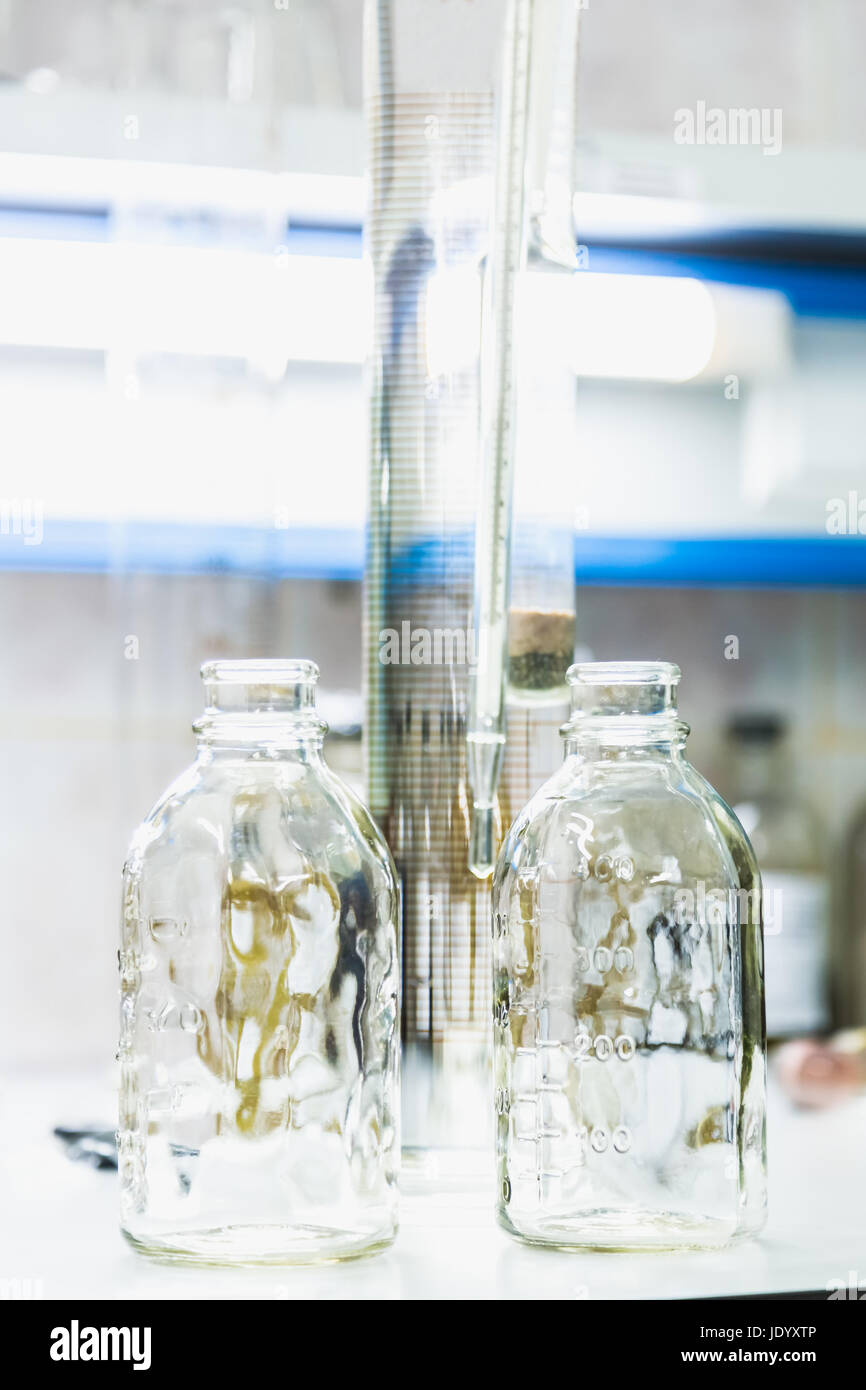 Empty glass bottles on table. Research laboratory glassware Stock Photo ...