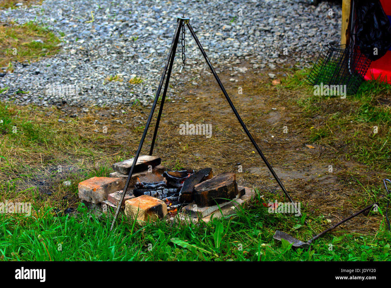 Cooking on a fire in the open air, fire, stand on three supports under ...
