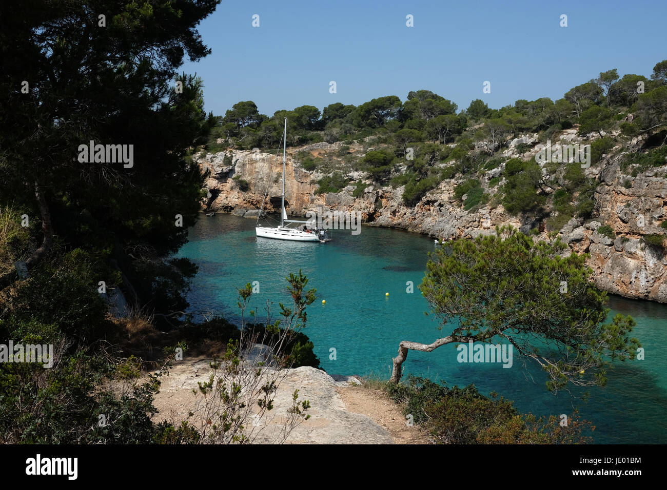 A sailboat at anchor off the Cala Pi bight in the south of the island ...