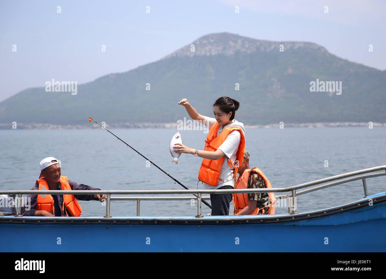 Dalian, China's Liaoning Province. 22nd June, 2017. Tourists catch fish ...