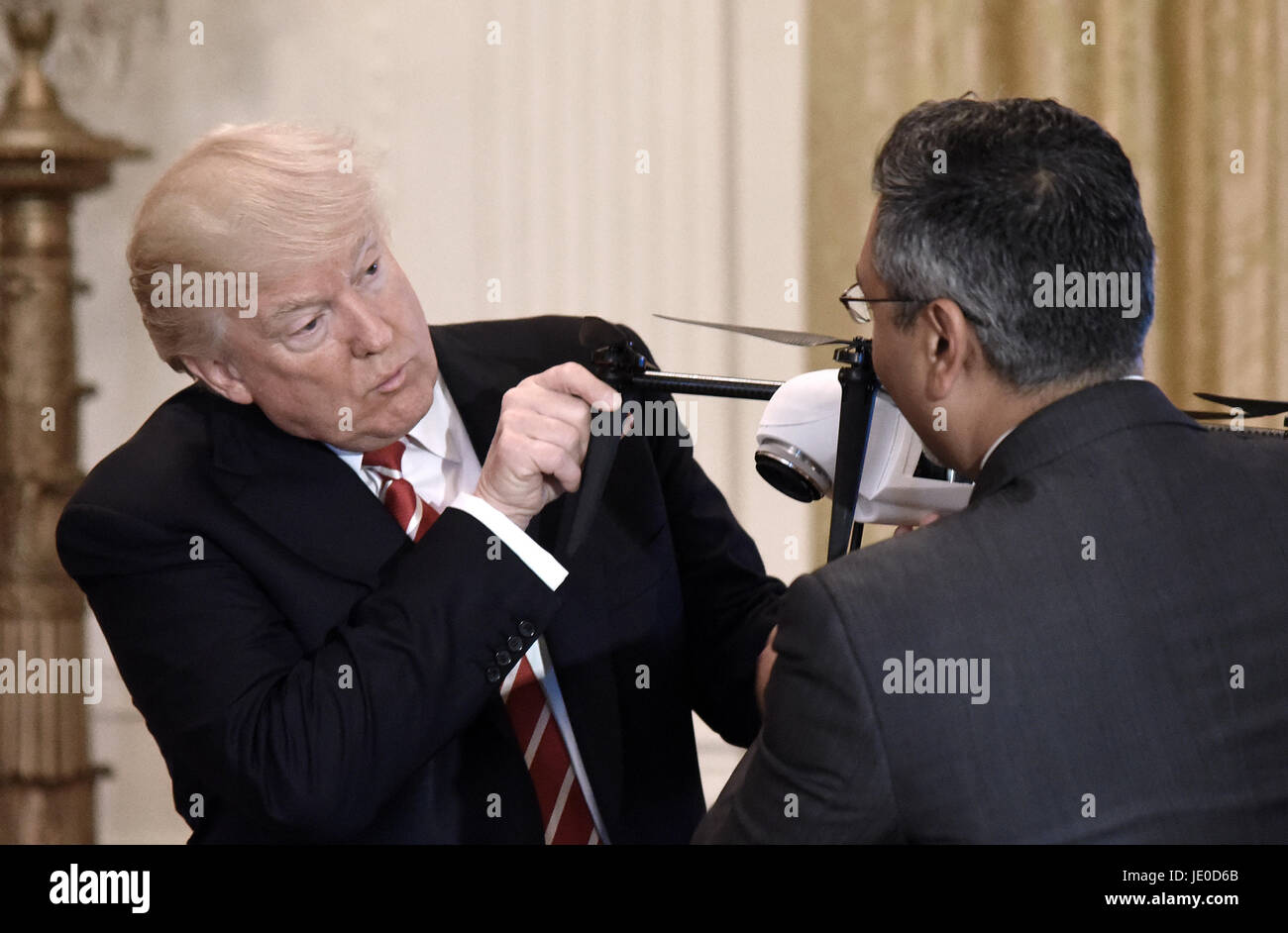 United States President Donald J. Trump holds a drone as George Mathew ...