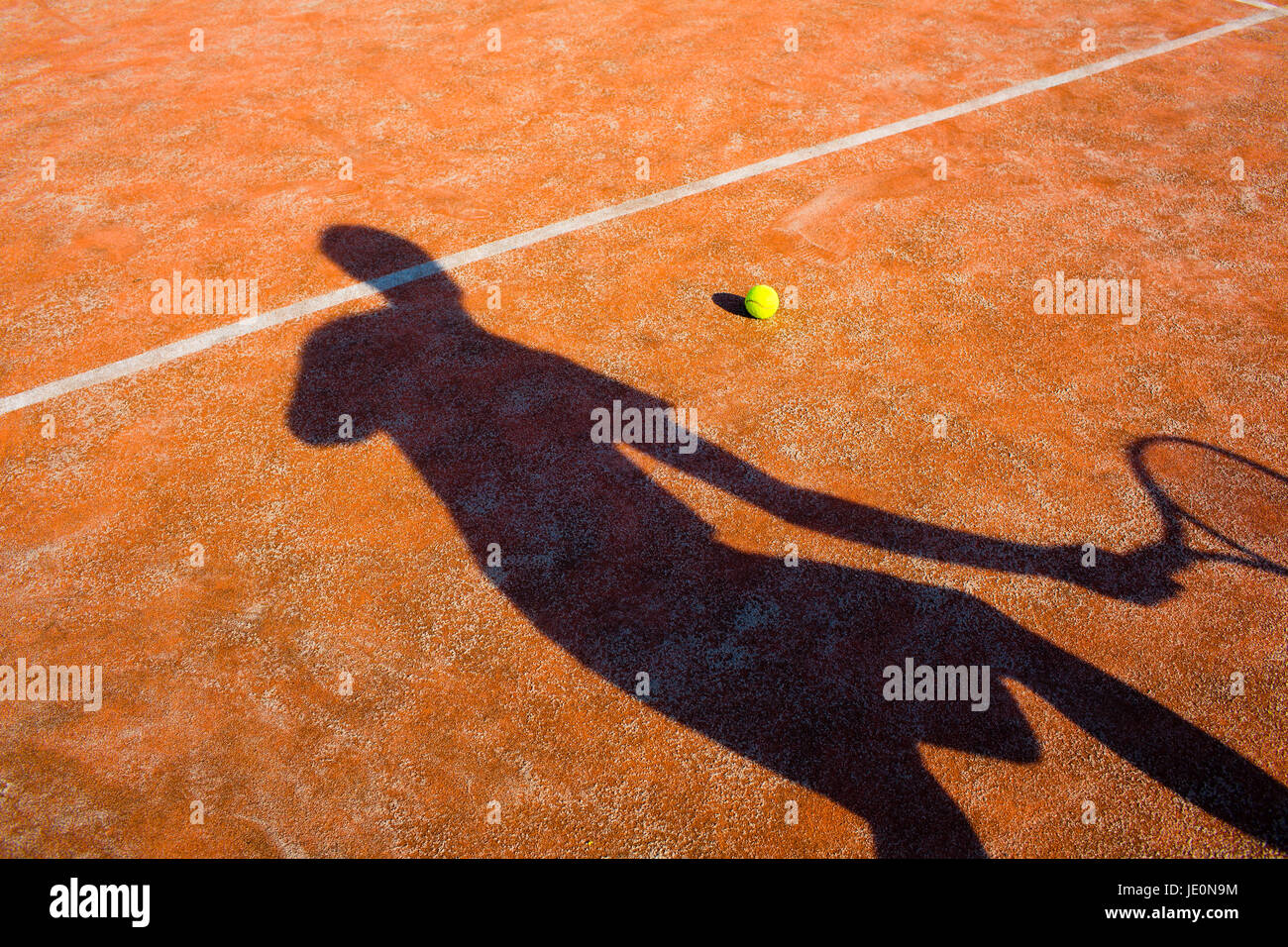 Shadow of a tennis player in action on a tennis court (conceptual image ...