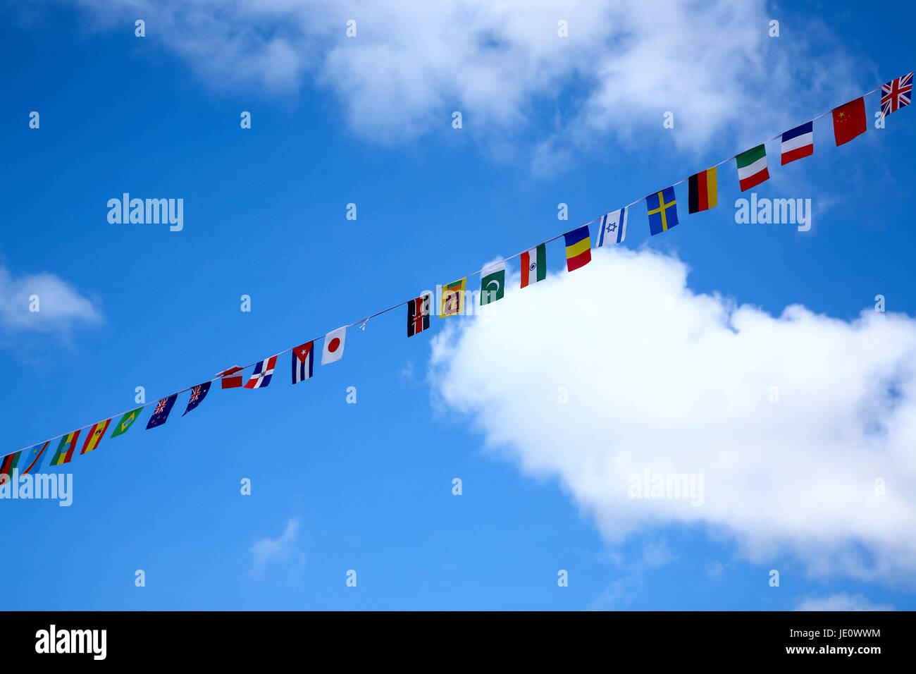 Flags of the world blowing in the breeze on a warm sunny spring day ...