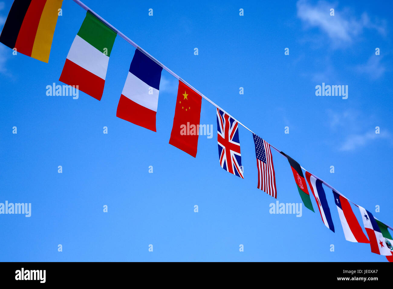 Flags of the world blowing in the breeze on a warm sunny spring day ...