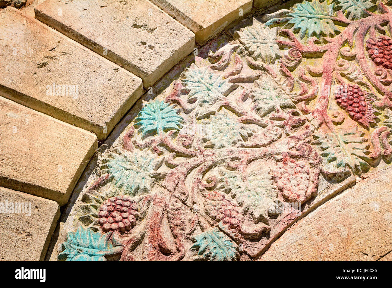 Fragment of the ancient gate decorated with the image of grapes ...